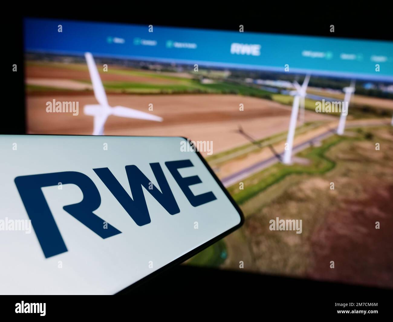 Cellphone with logo of German energy company RWE AG on screen in front of business website ...