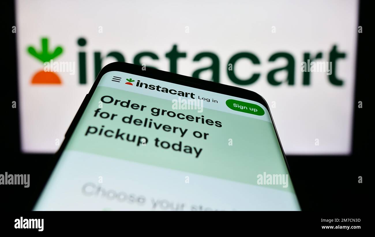 Mobile phone with website of US retail company Maplebear Inc ...