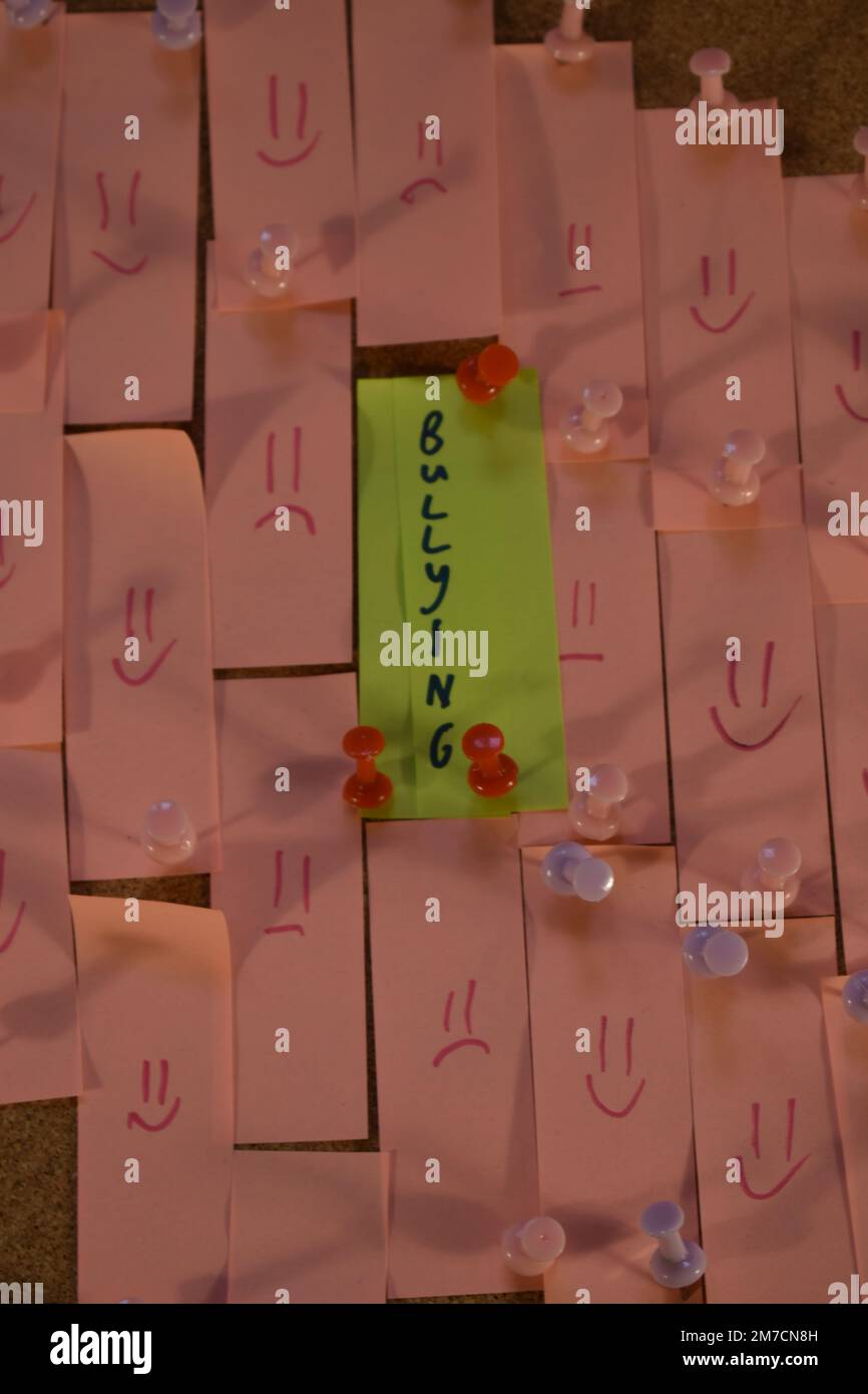 Bullying message on a paper on a pinboard Stock Photo - Alamy