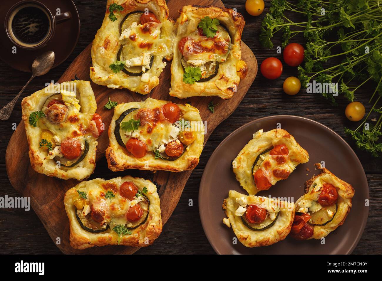 Crispy puff pastry mini tarts with zucchini, tomatoes and cheese Stock ...