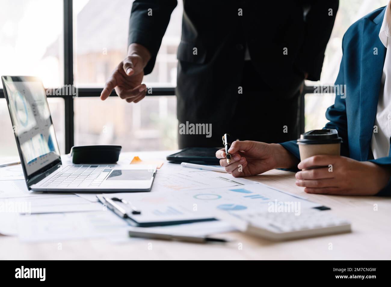 Business People Meeting using chart graph calculator, laptop computer ...