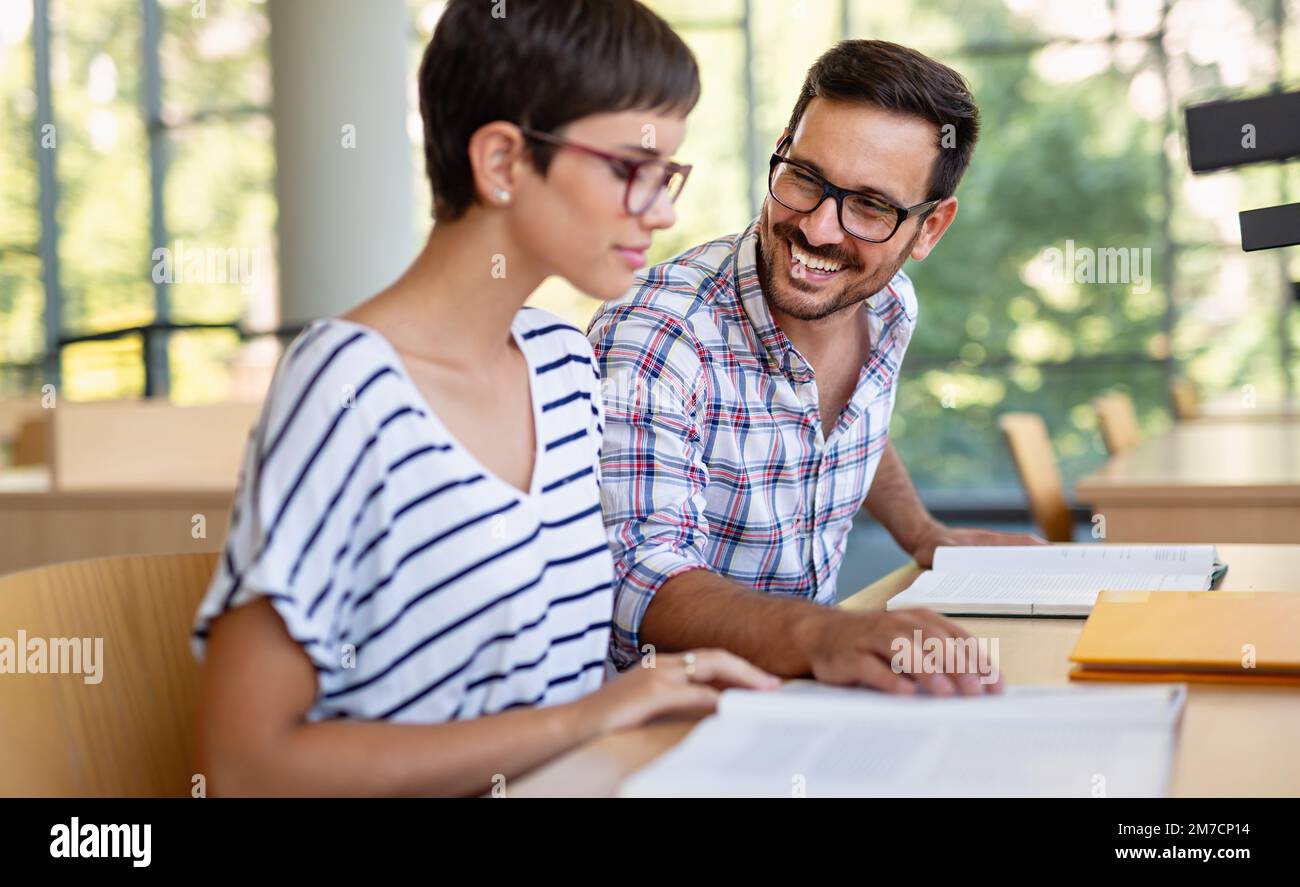 Happy group of students studying and working together in a college ...