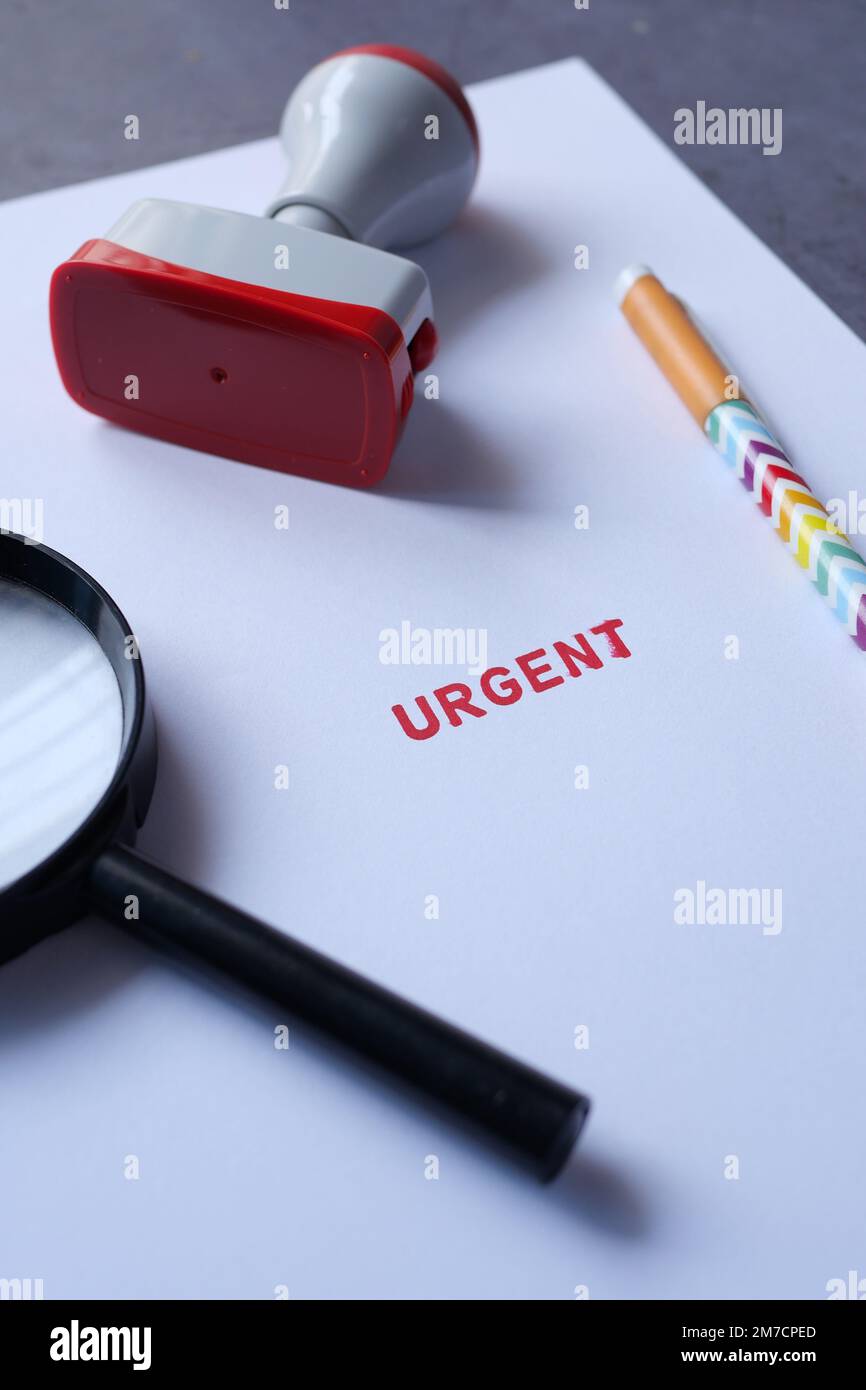 Red URGENT word stamp on a white paper Stock Photo - Alamy