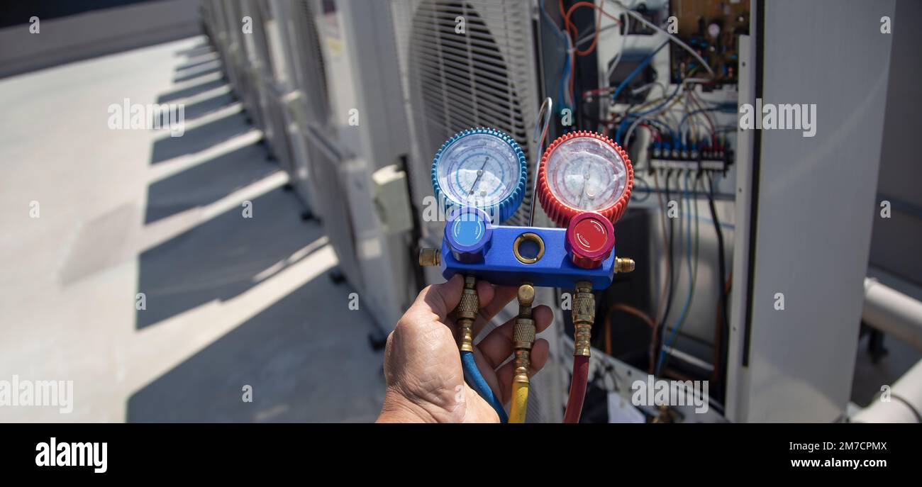Air conditioner technician checking air conditioner operation Stock ...