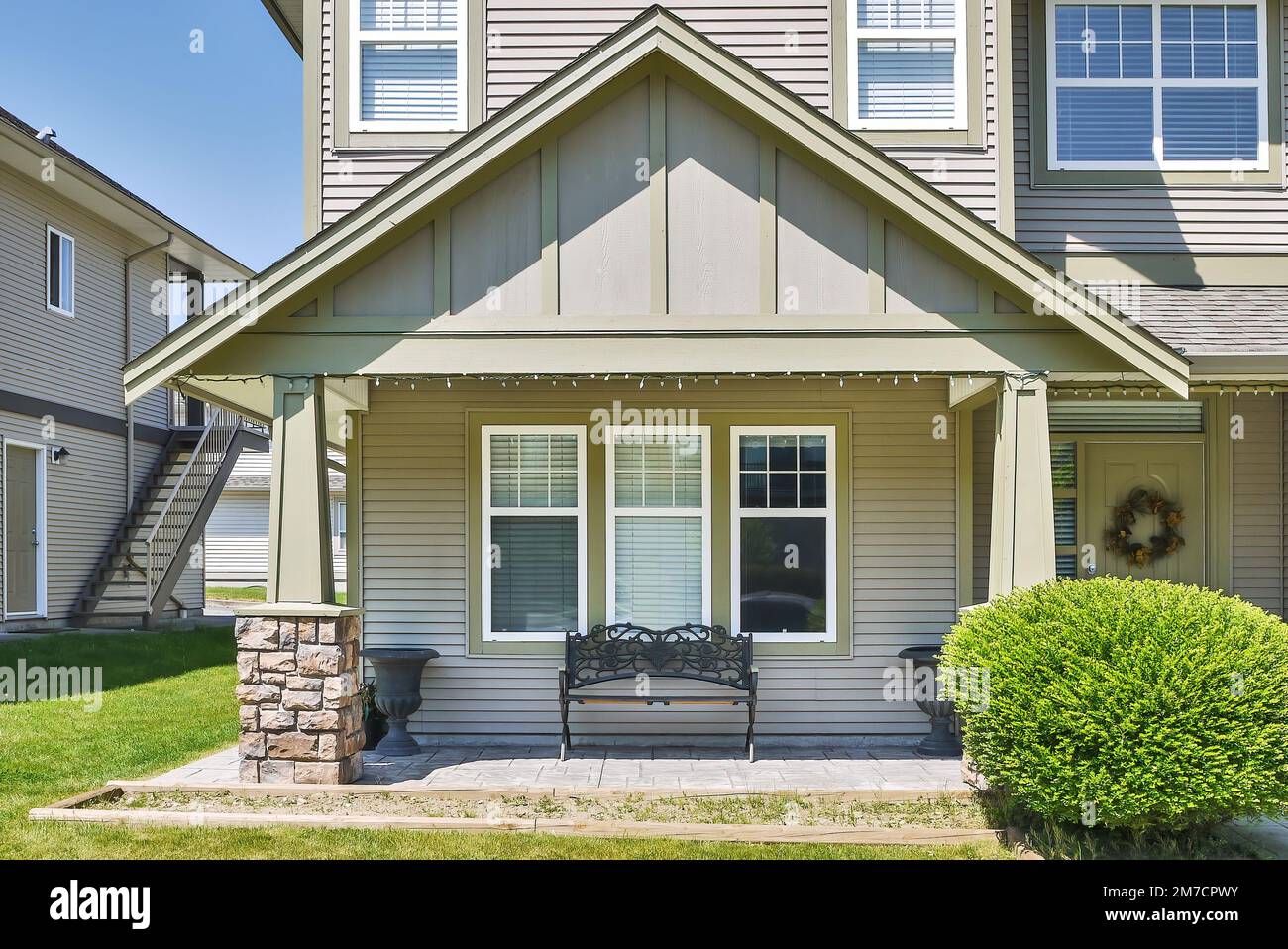 Facade of family house with casted bench at the window beside the ...