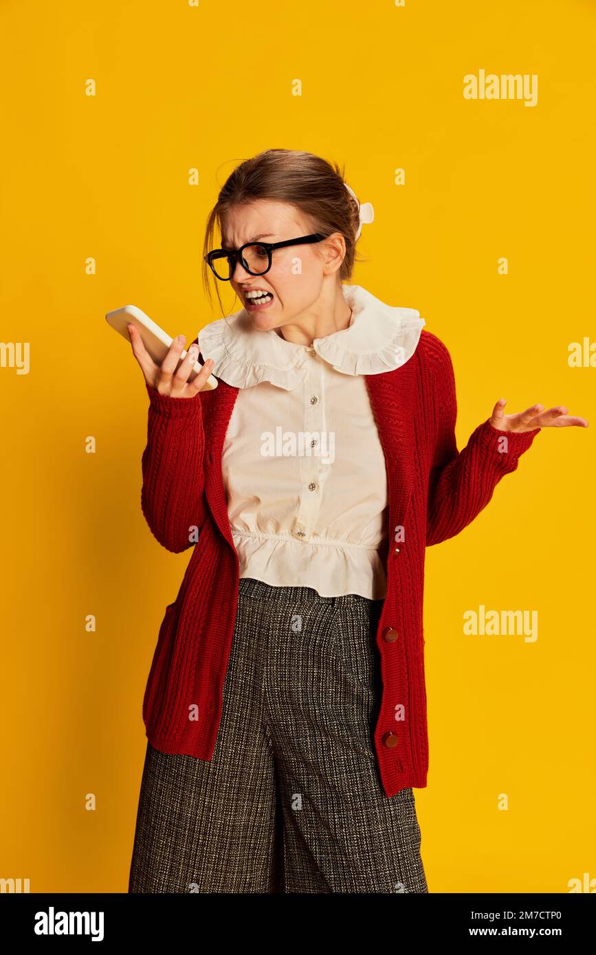 One young girl wearing old-fashioned outfit posing over yellow ...