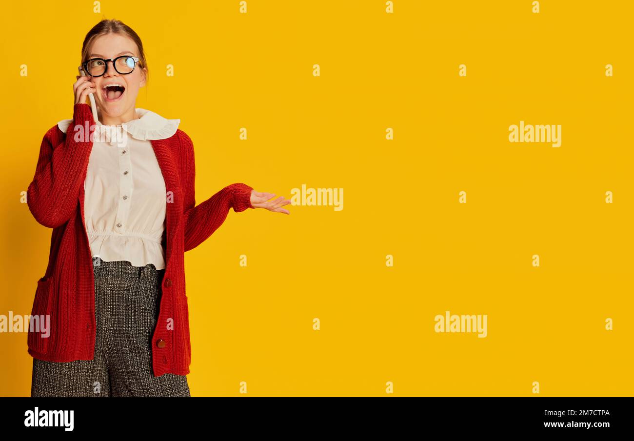 One young girl wearing old-fashioned outfit posing over yellow ...