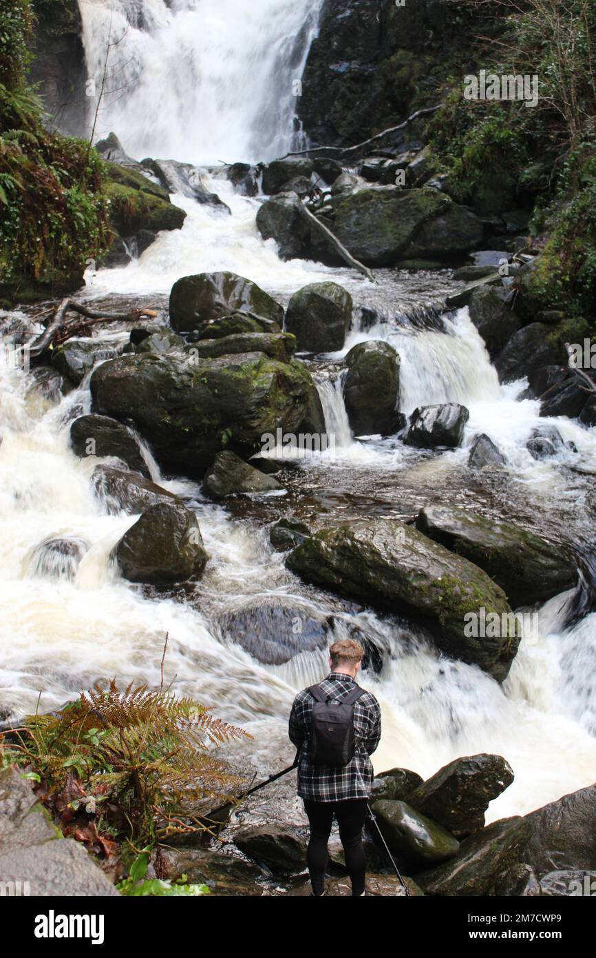Photographer out capturing Torc Waterfall after heavy rains. Nature ...