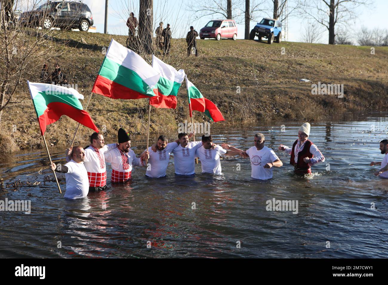 People perform the folk dance "Horo" with national flags in the icy ...