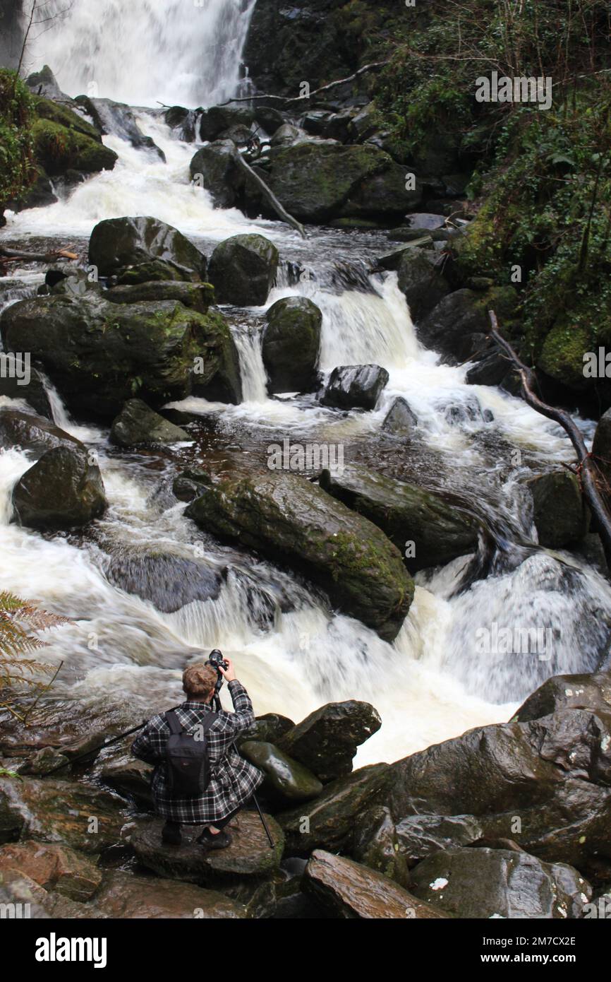 Photographer capturing Torc Waterfall after heavy rains. Nature ...