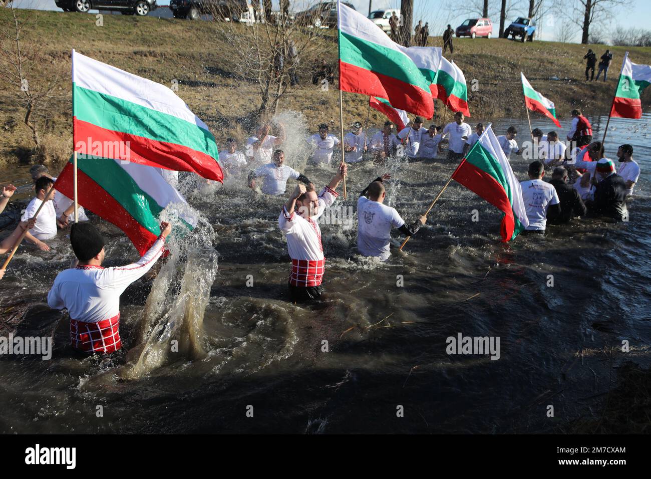 People perform the folk dance "Horo" with national flags in the icy ...
