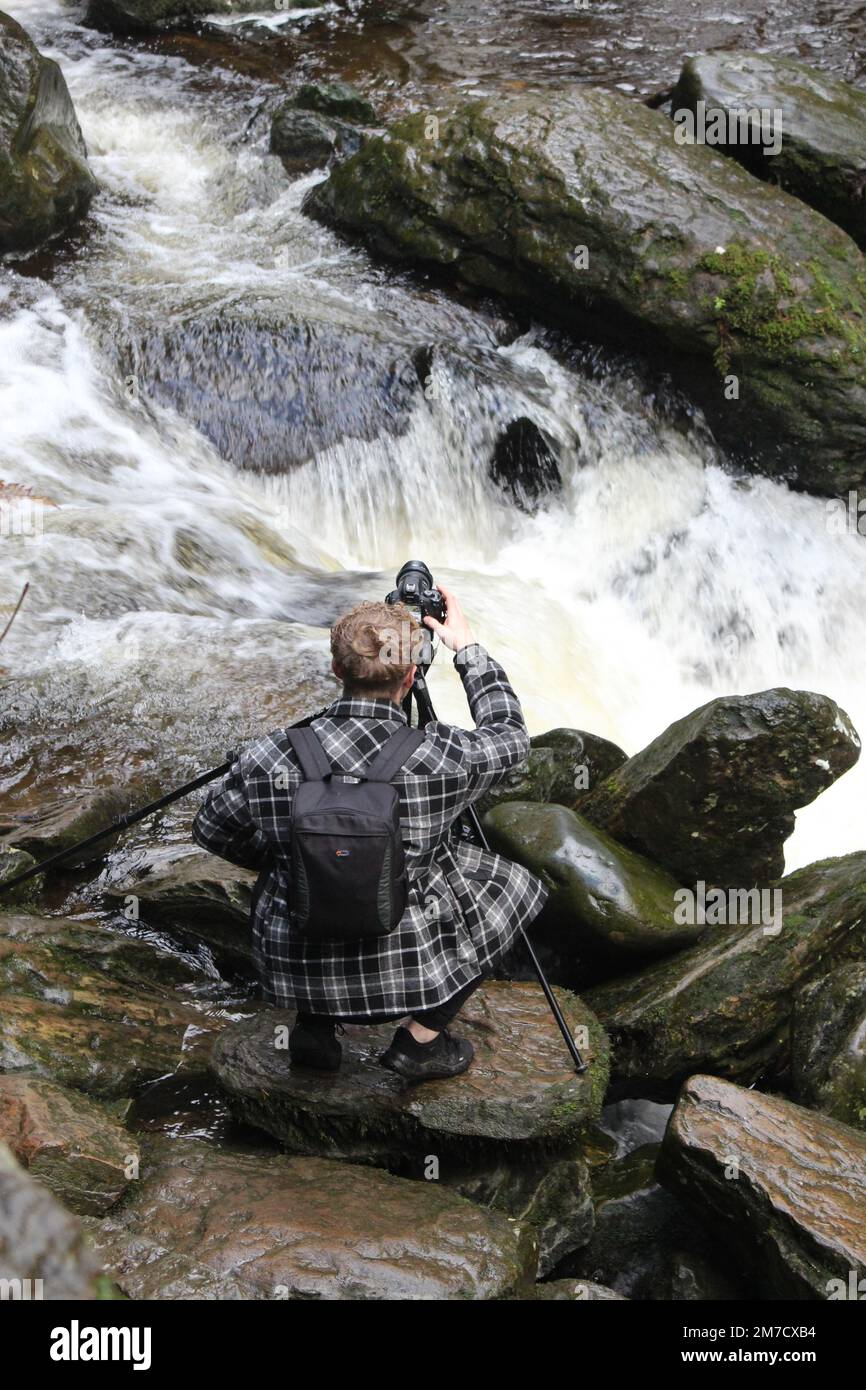 Photographer capturing Torc Waterfall after heavy rains. Nature ...