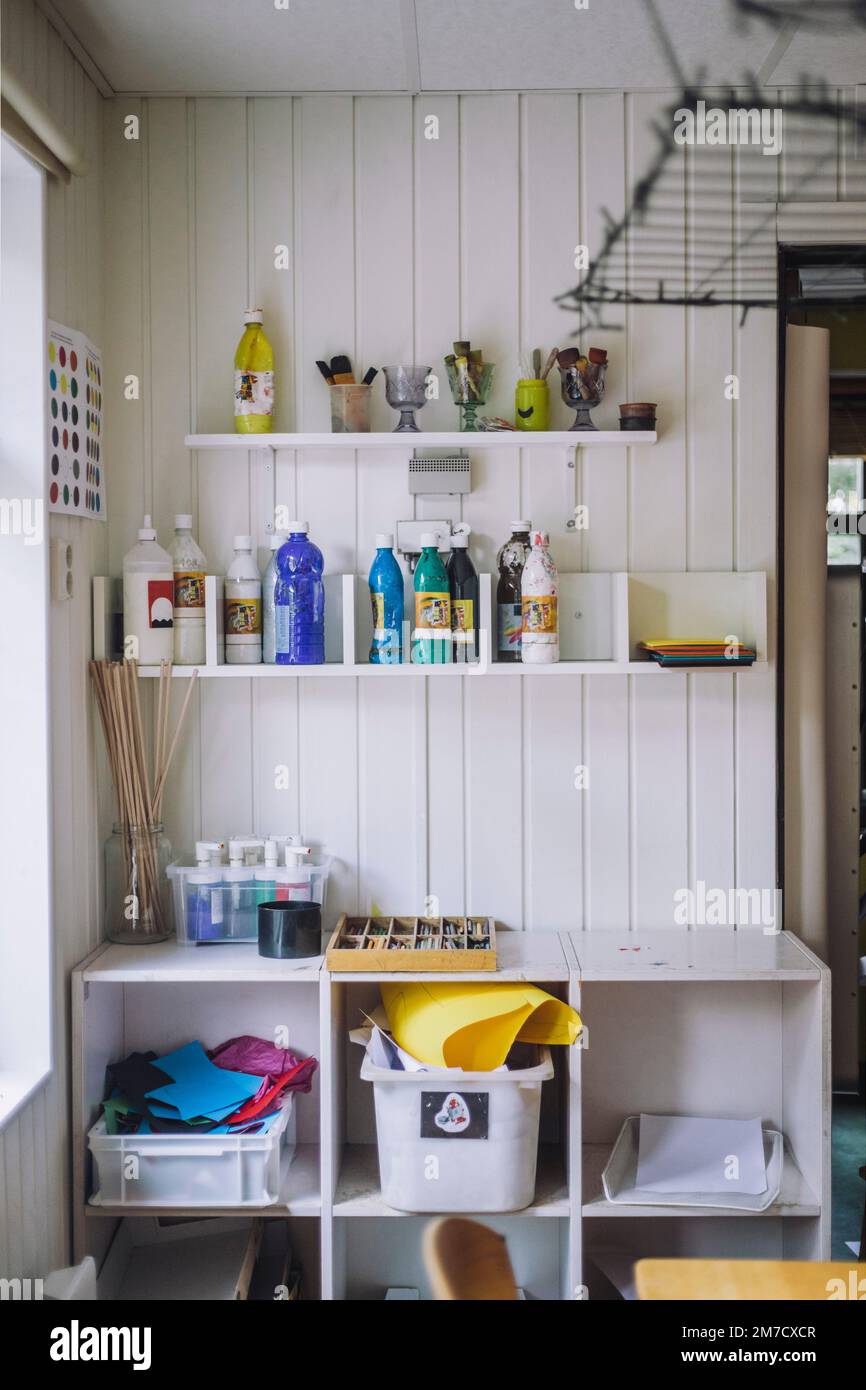 Boxes and glue bottles arranged on rack in storage room Stock Photo - Alamy