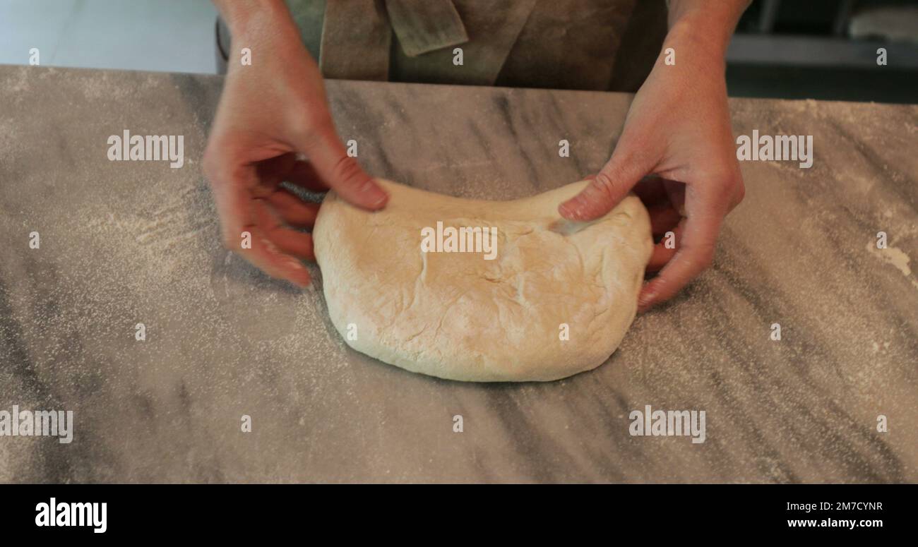 Baker Preparing kneading traditional dough bread and cakes with hand ...