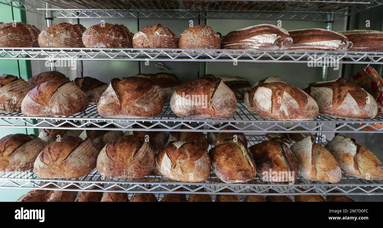 Traditional breads stacked together on shelf at bakery Stock Photo - Alamy