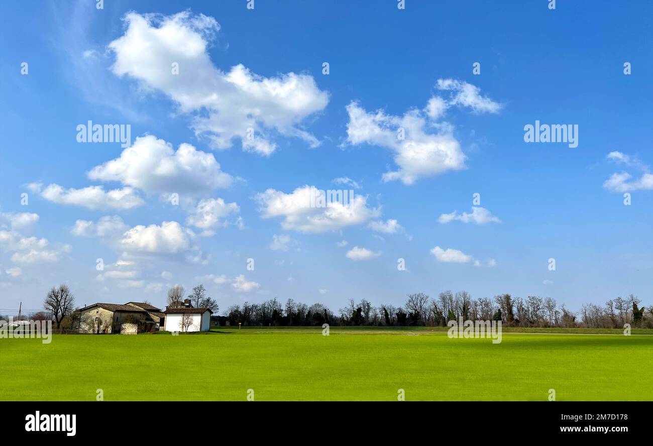 Rural landscape cultivated field with farm house Stock Photo - Alamy