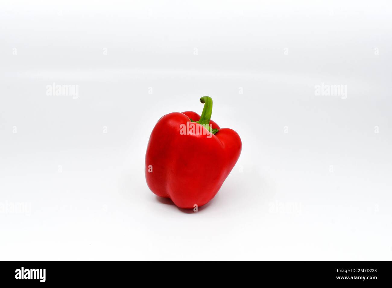 Single red pepper on a plain white background. Copy space Stock Photo ...