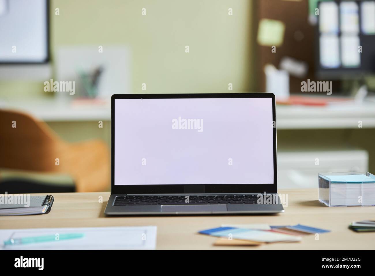 Background image of open laptop with white screen mock up on desk in ...