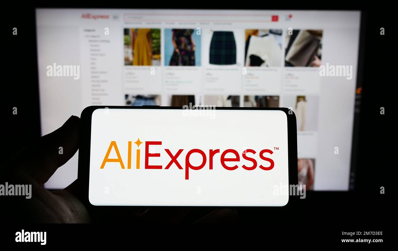 Person holding smartphone with logo of Chinese c-commerce company ...