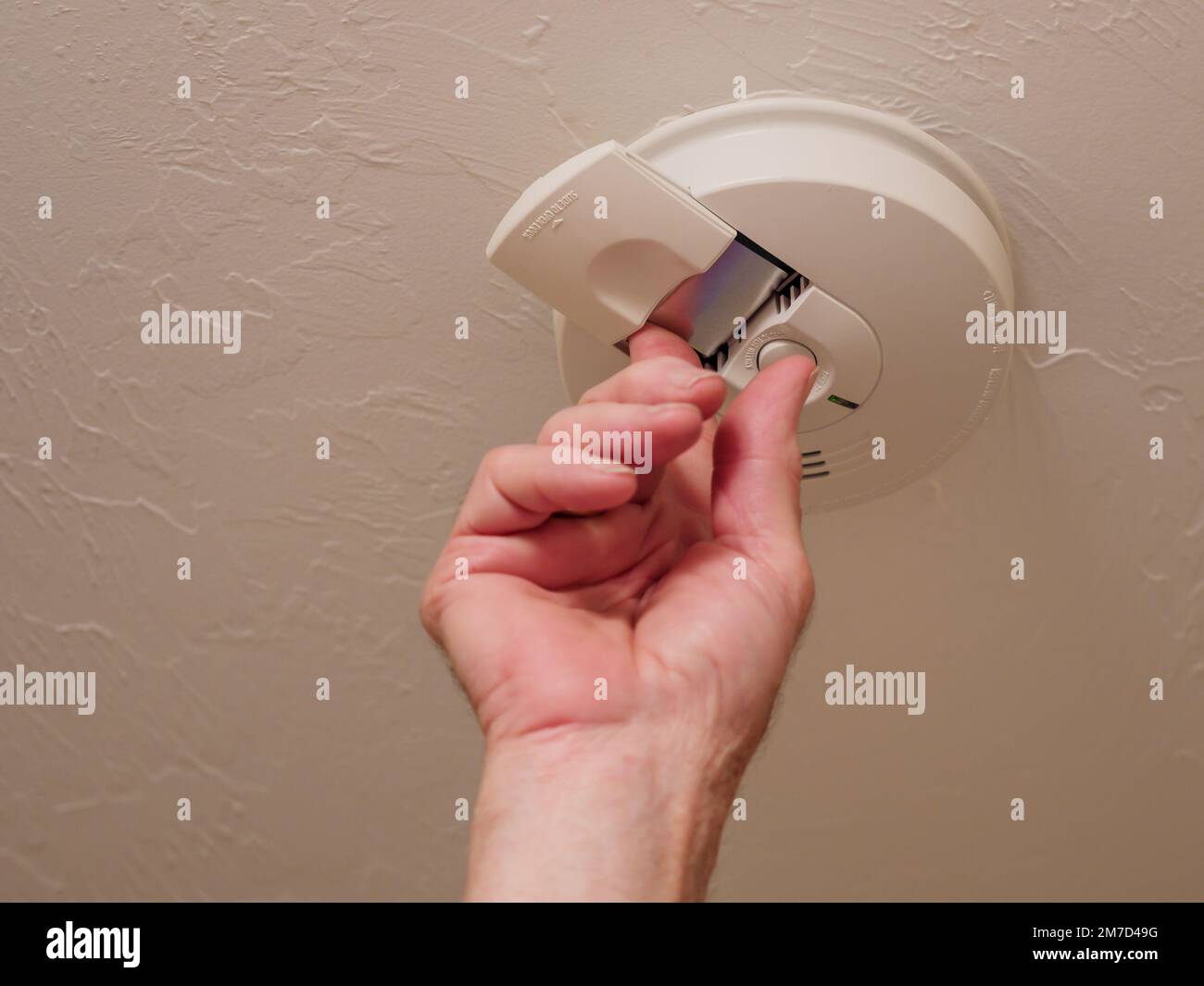 Replacing battery in home ceiling smoke detector fire alarm Stock Photo ...