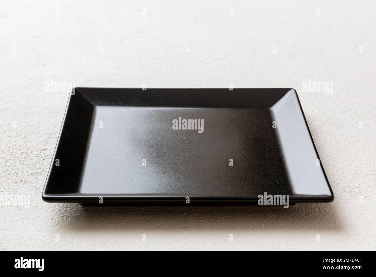 Perspective view of empty square plate on cement background. Empty ...