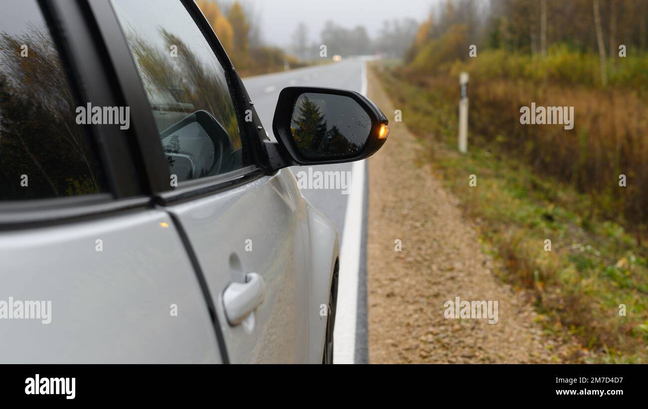 Right turn indicator signalling on the car side view mirror Stock Photo ...