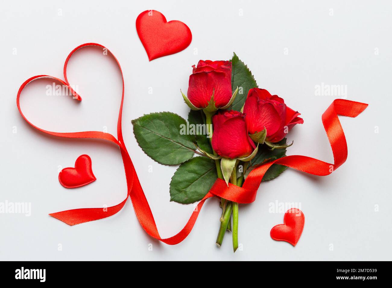 Valentine day composition with rose flower and red heart on table. Top ...