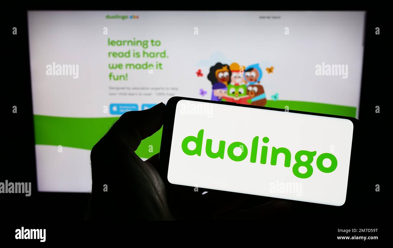 Person holding cellphone with logo of educational technology company ...