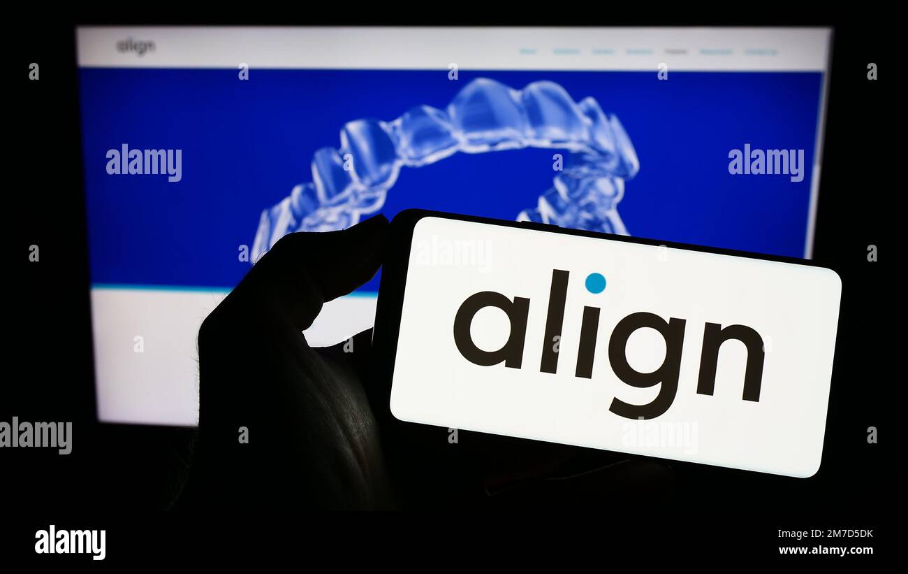 Person holding mobile phone with logo of US orthodontics company Align ...