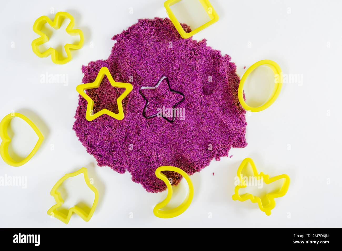 Purple kinetic sand, plastic molds for sand. Top view. White background ...