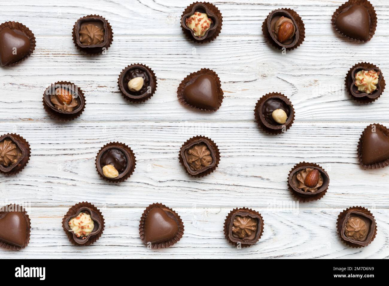 Different kinds of chocolates on colored table close-up. Top View and ...