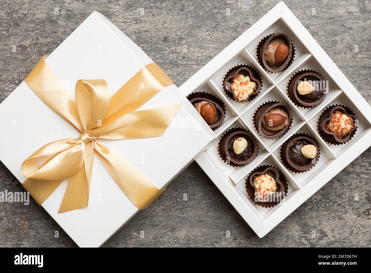 White box with chocolates candies and golden tape. top view with copy ...