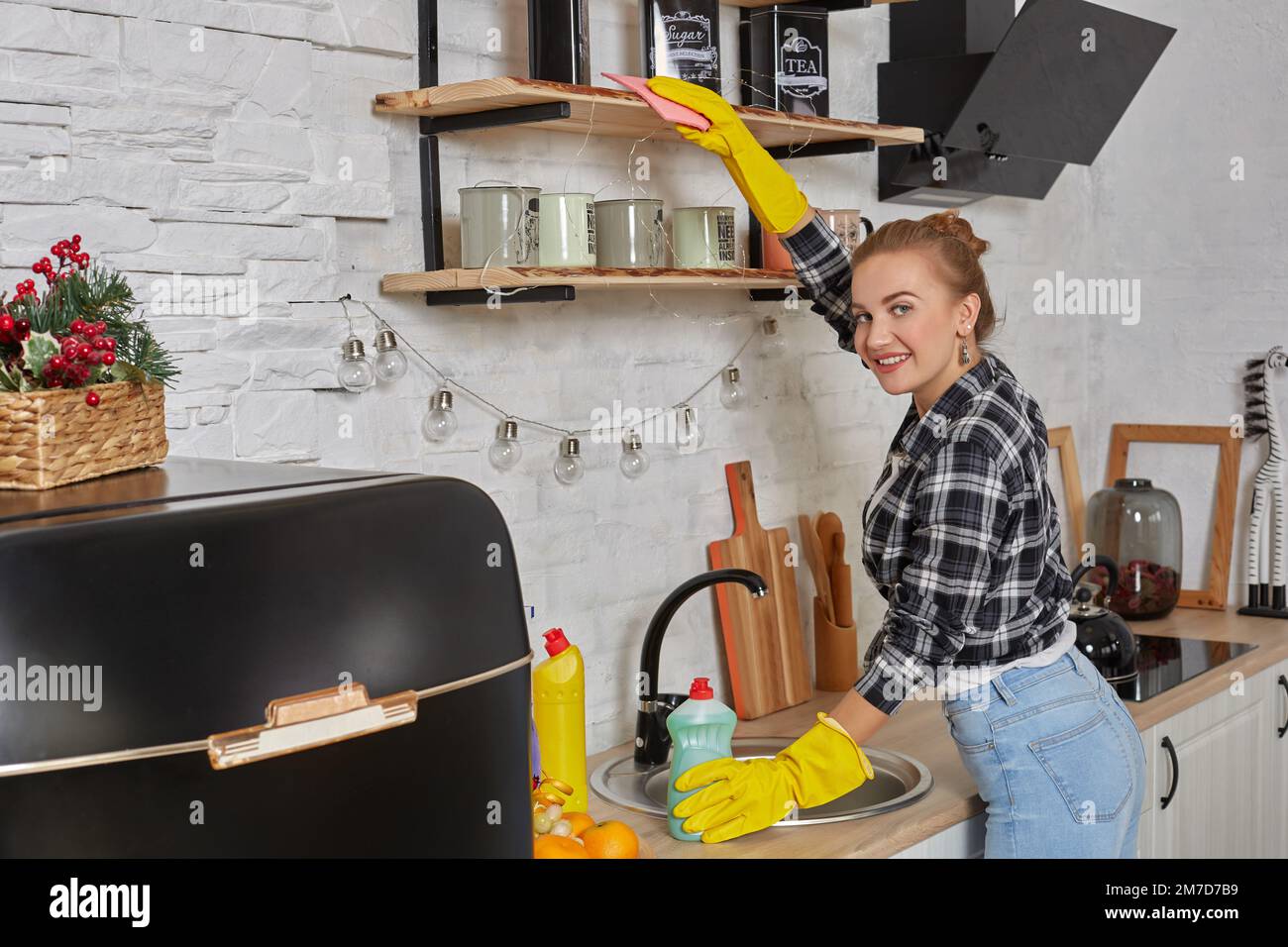 Woman in gloves cleaning furniture with rag at home kitchen Stock Photo ...