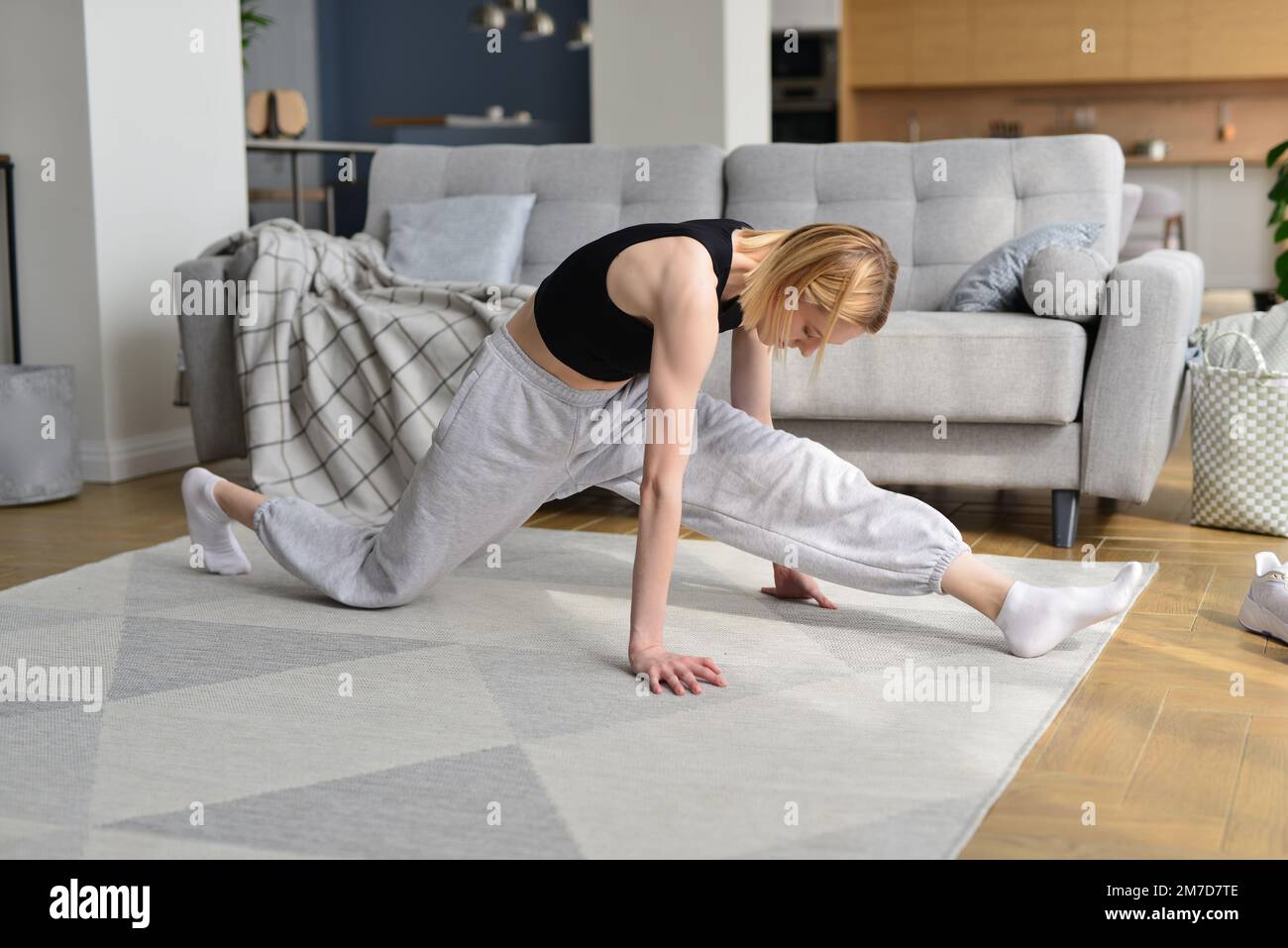 Woman working up forward splits warming up her legs Stock Photo - Alamy