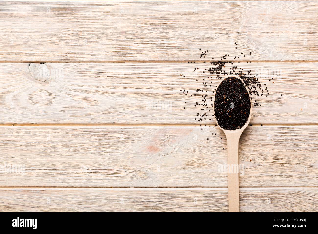quinoa seeds in spoon on colored background. Healthy kinwa in small ...