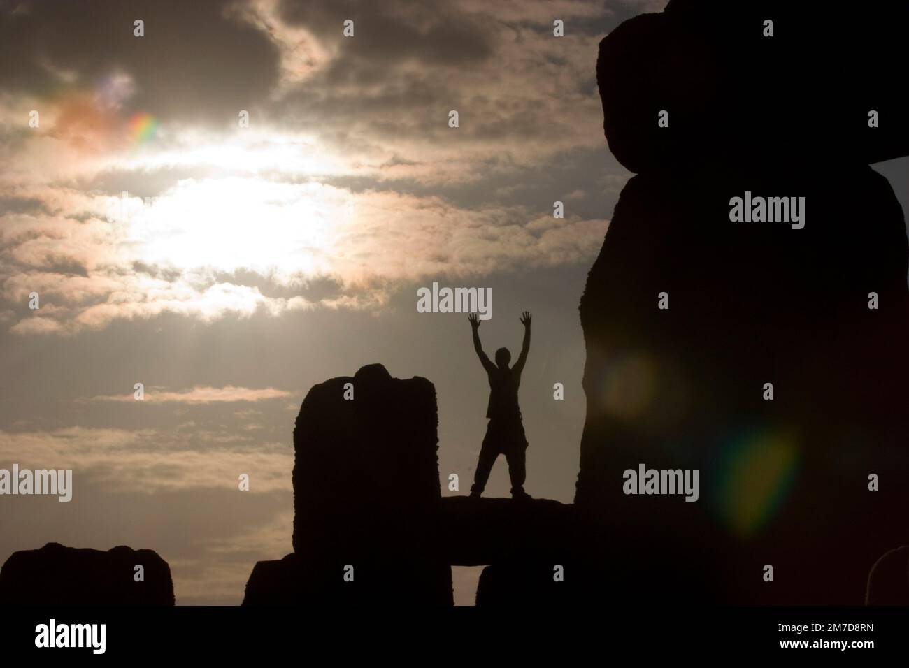 The sun can be seen rising behind the ancient stones at Stonehenge ...