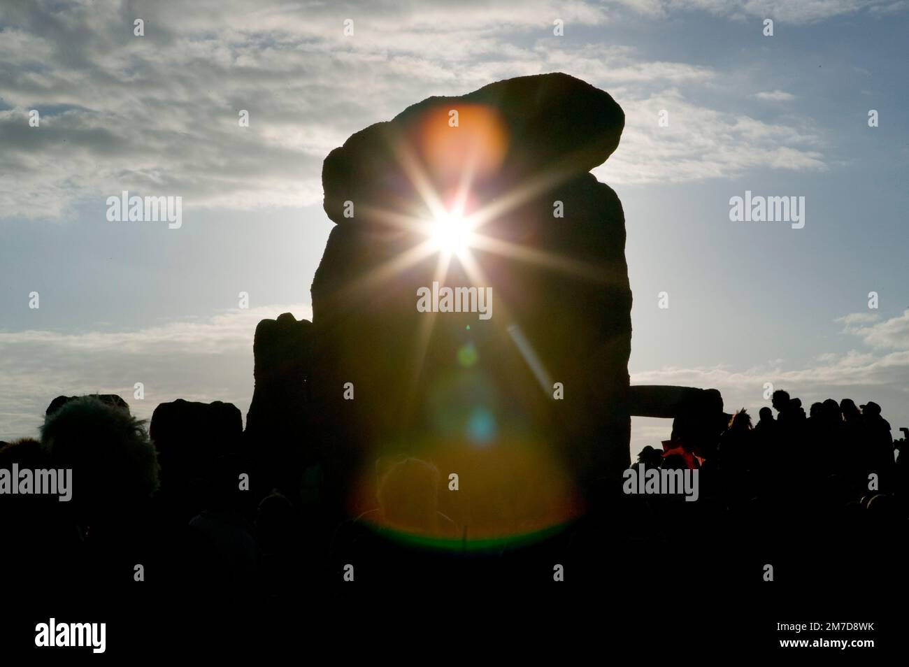 The sun can be seen rising behind the ancient stones at Stonehenge ...