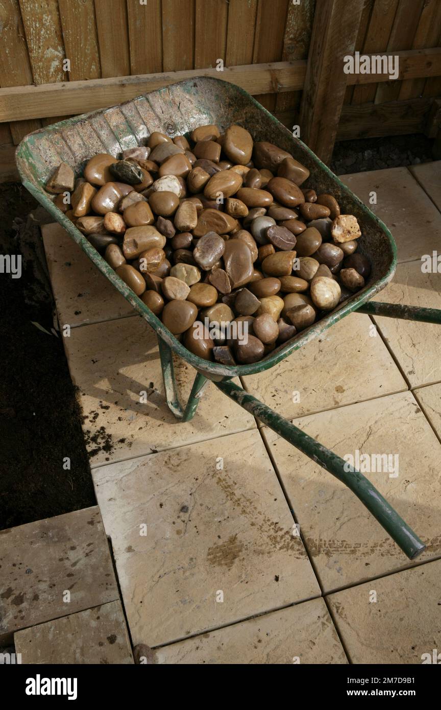 Preparing hard standing and decking areas in a small garden and laying ...