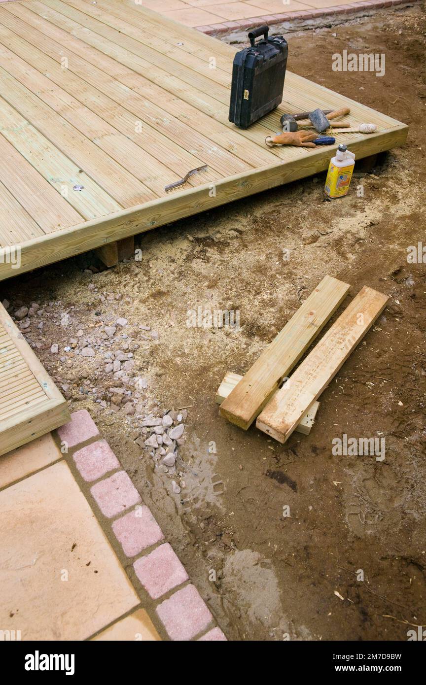 Preparing hard standing and decking areas in a small garden and laying ...