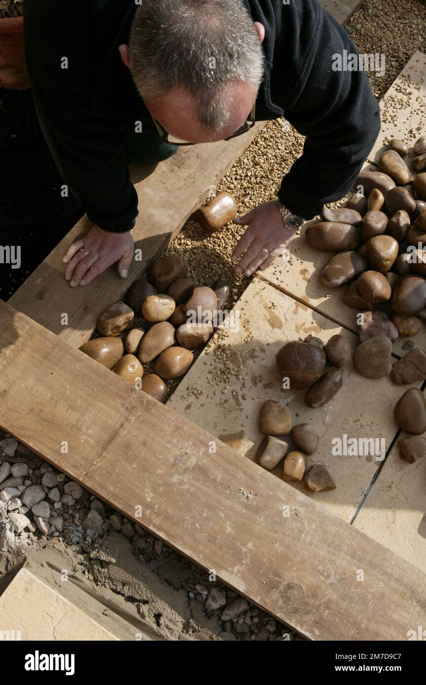 Preparing hard standing and decking areas in a small garden and laying ...