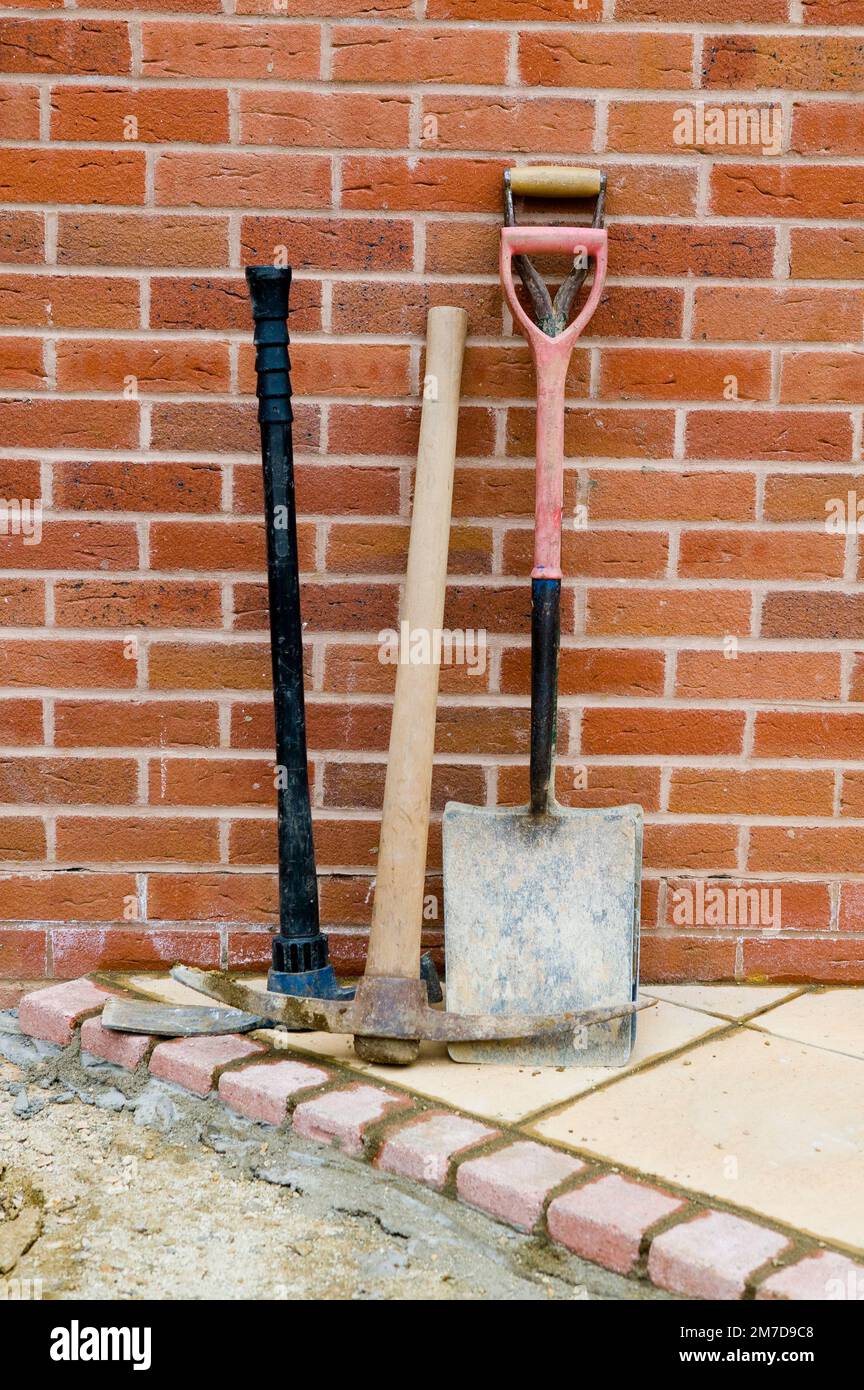 Preparing hard standing and decking areas in a small garden and laying ...