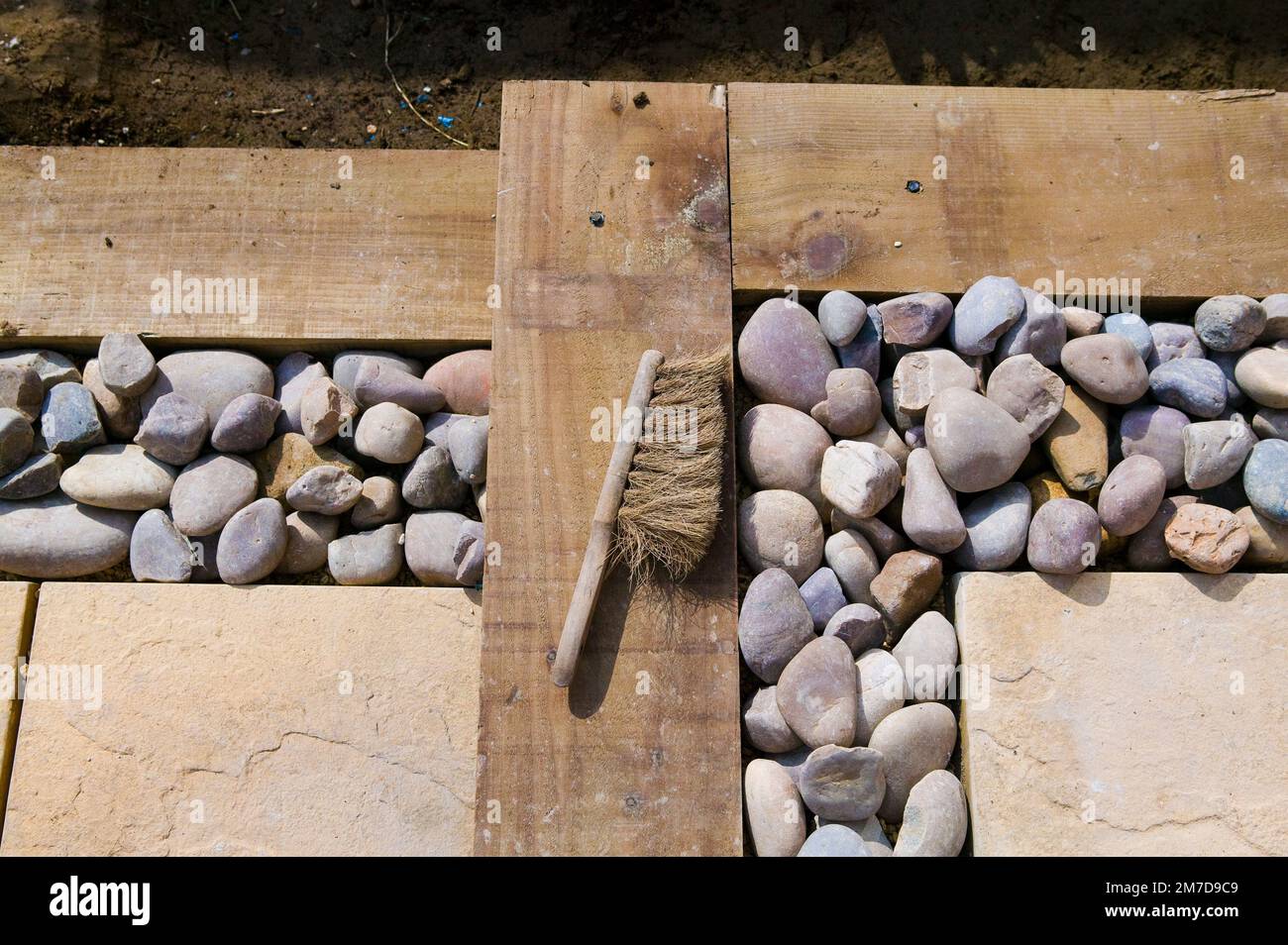 Preparing hard standing and decking areas in a small garden and laying ...