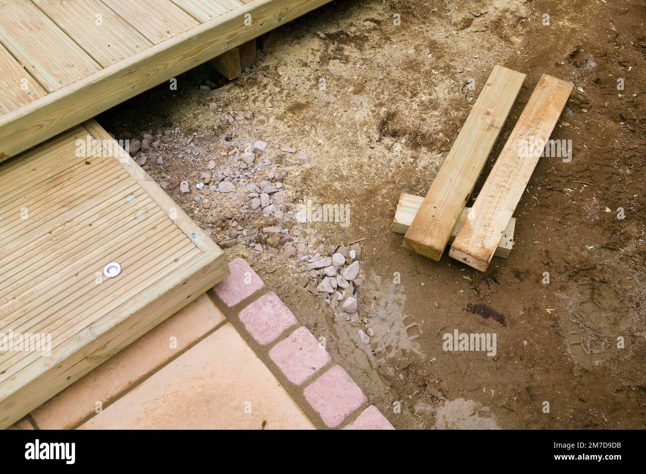 Preparing hard standing and decking areas in a small garden and laying ...