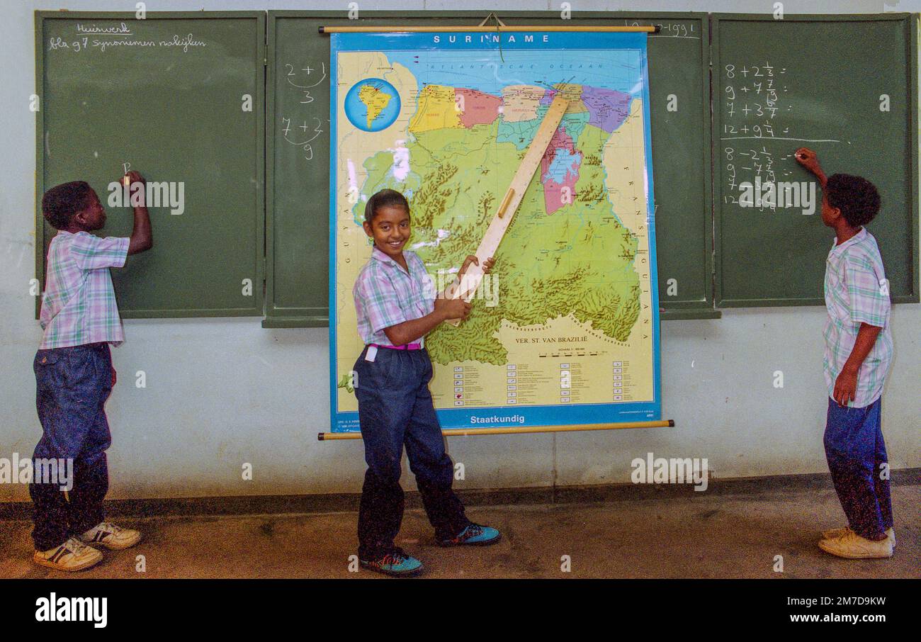 Surinam, Paramaribo. Schoolgirls in their school uniform in a primary ...