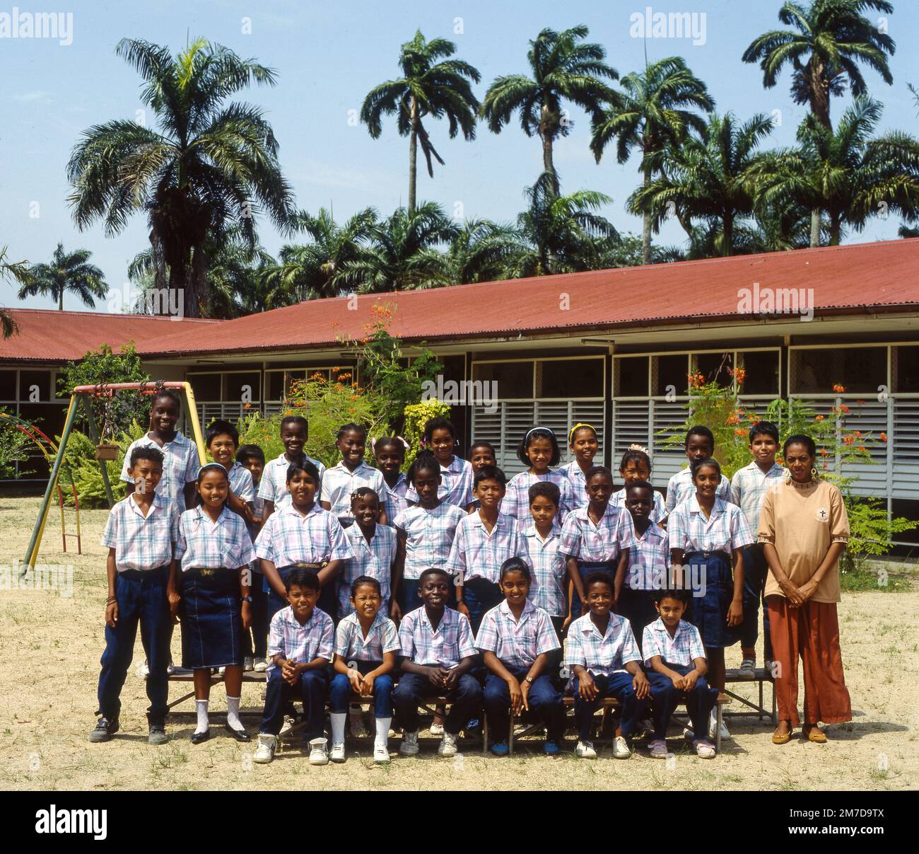 Surinam, Paramaribo. pupils and teacher have a class photo taken in ...