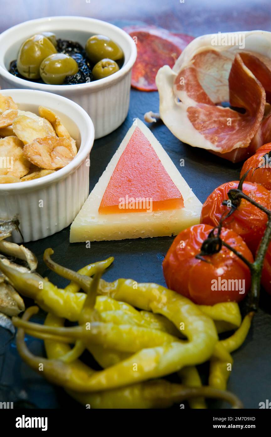 A plate of Spanish style tapas food on a grey slate in restaurant Stock ...