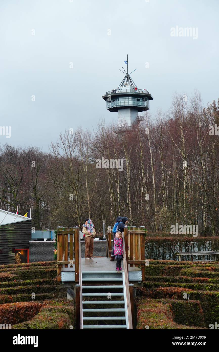 A vertical of people on a bridge of a labyrinth at the Drielandenpunt ...