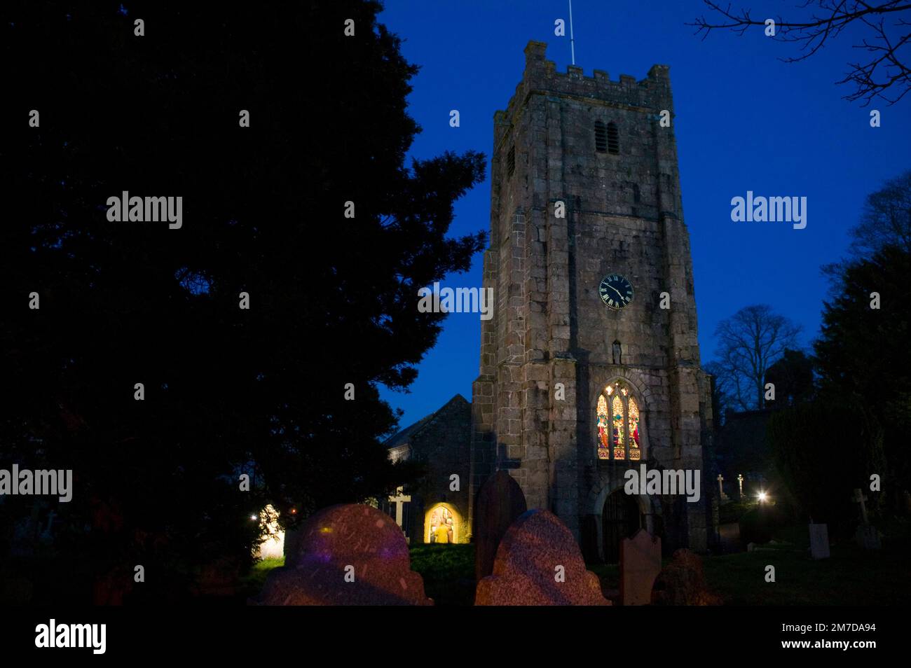 A traditional church and graveyard shown here in the twilight and ...