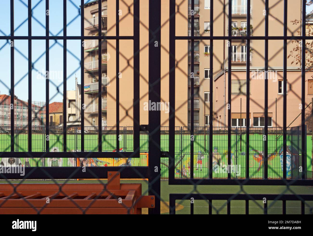 fenced football pitch in urban setting, Italy Stock Photo - Alamy