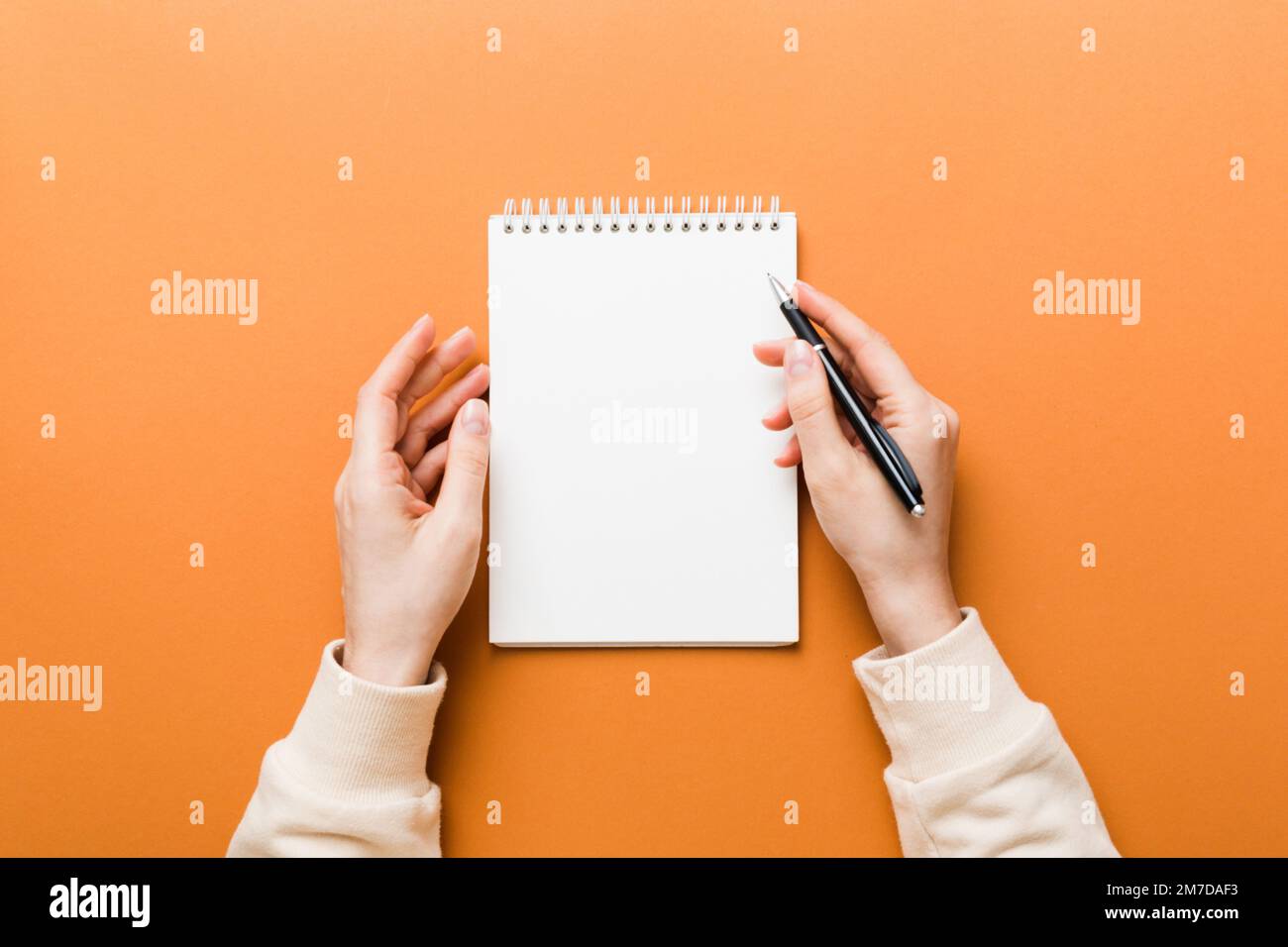 Woman hand with pencil writing on notebook. Woman working on office ...